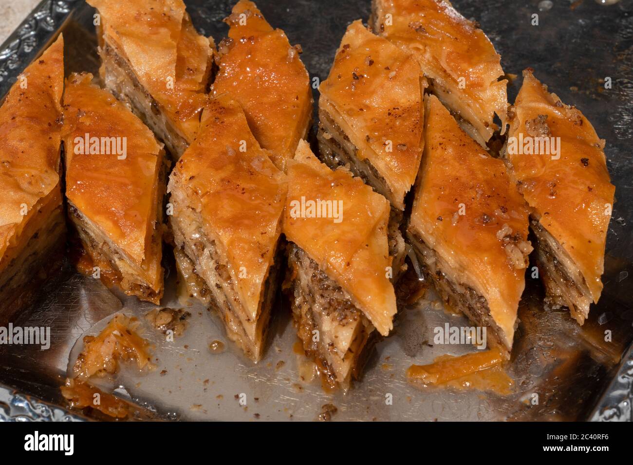 Diamond shape homemade Turkish baklava. Baklava in a metal tray ...