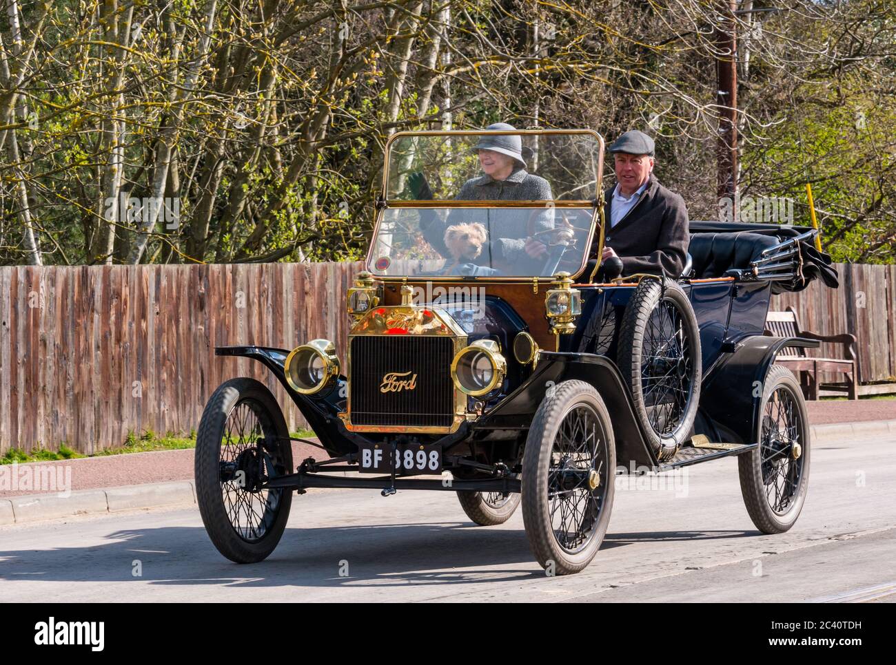 Couple I period costume driving in open vintage Ford vehicle, Great ...