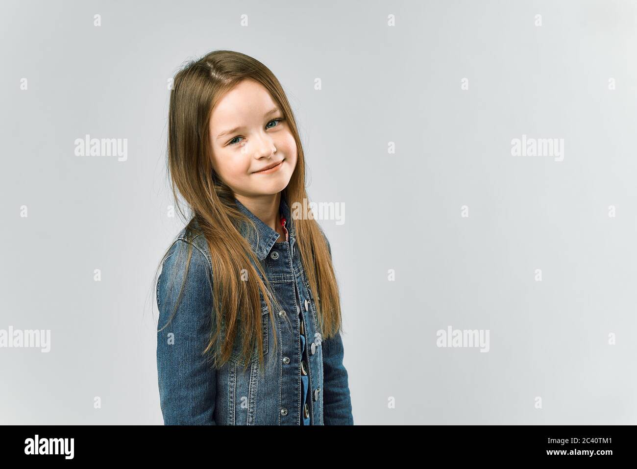portrait of a cute little girl. gray studio background Stock Photo - Alamy