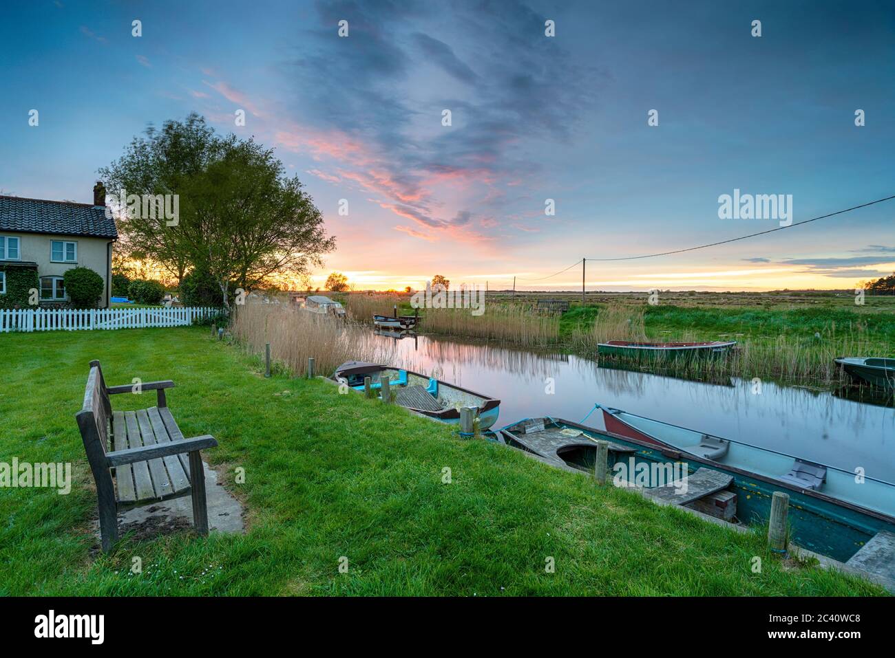 Sunset over boats on the river at West Somerton on the Norfolk Broads ...