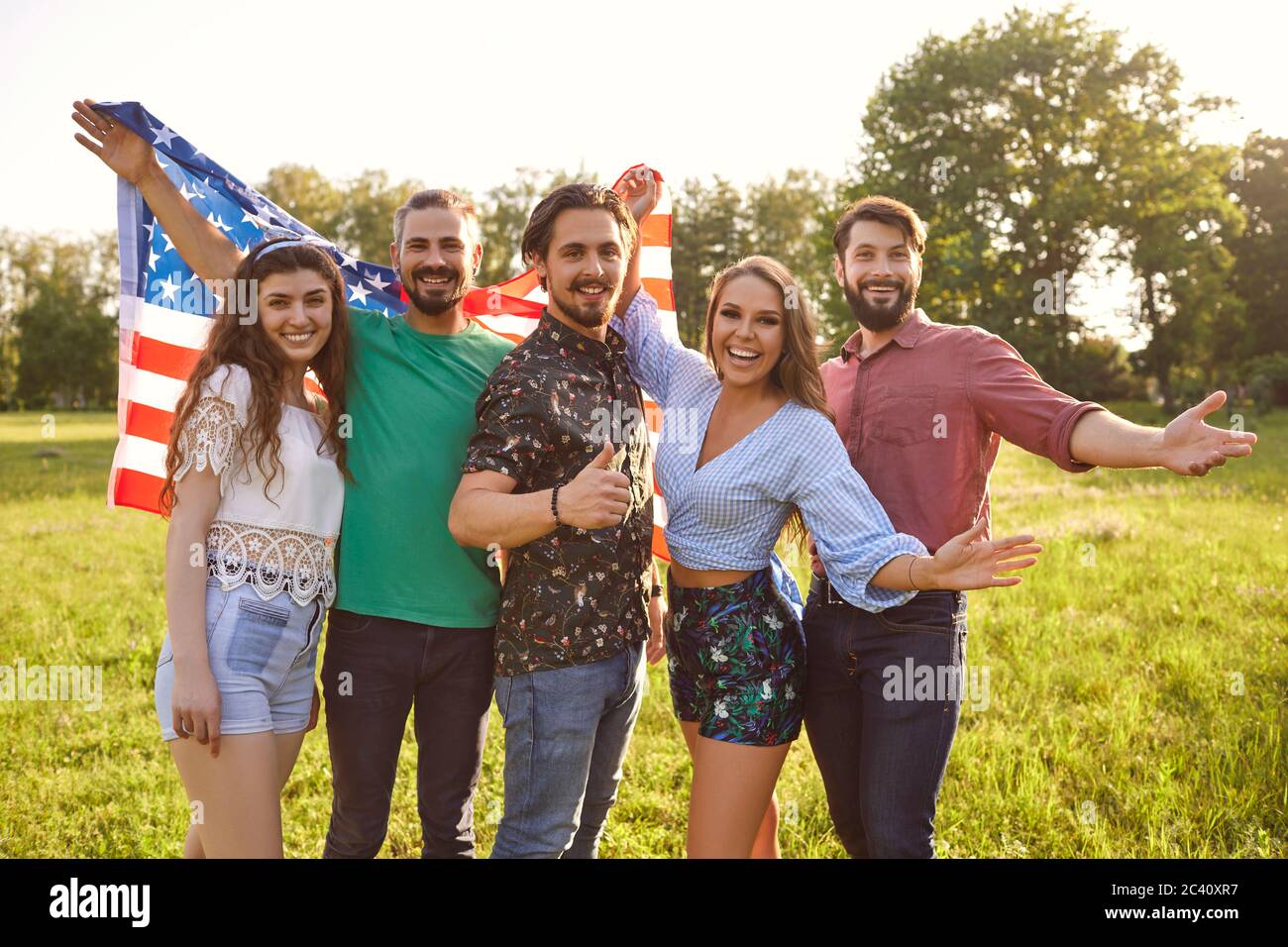 A group of happy young people have fun celebrating America's ...