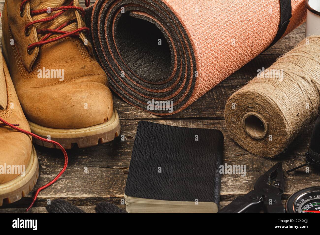 Hiking boots and rope hank on wooden board Stock Photo - Alamy