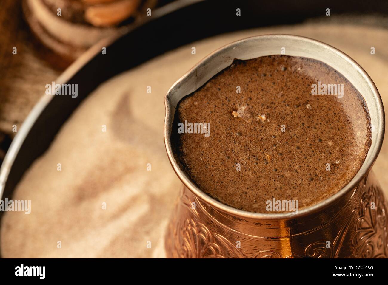 Turkish coffee prepared in sand with turk Stock Photo - Alamy