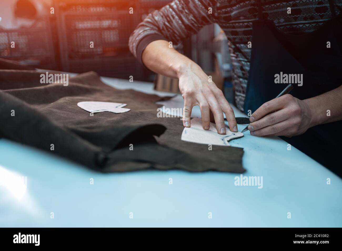 man shaping leather for shoe with knife on factory Stock Photo - Alamy