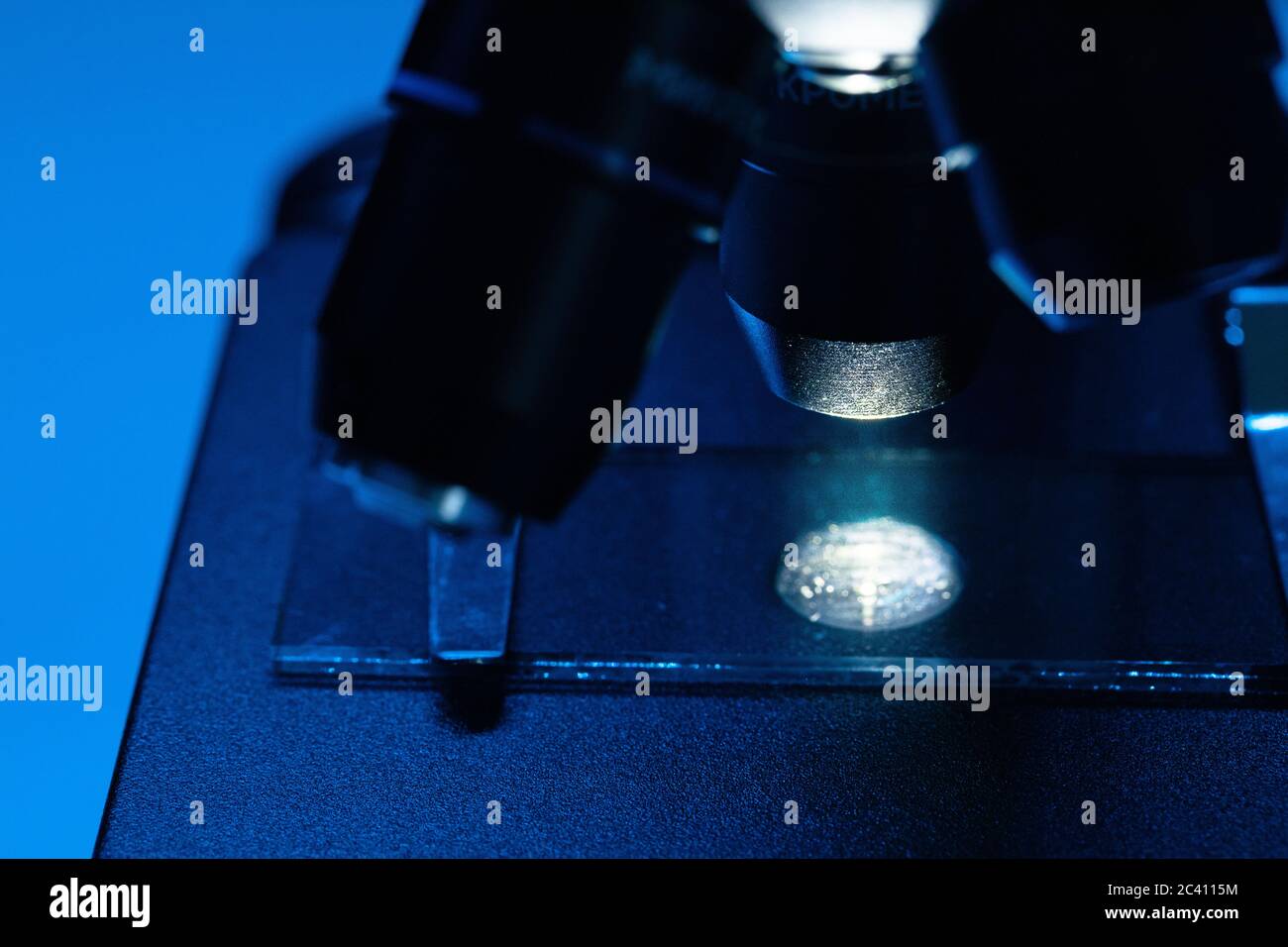 Microscope with lenses close up against dark background Stock Photo - Alamy