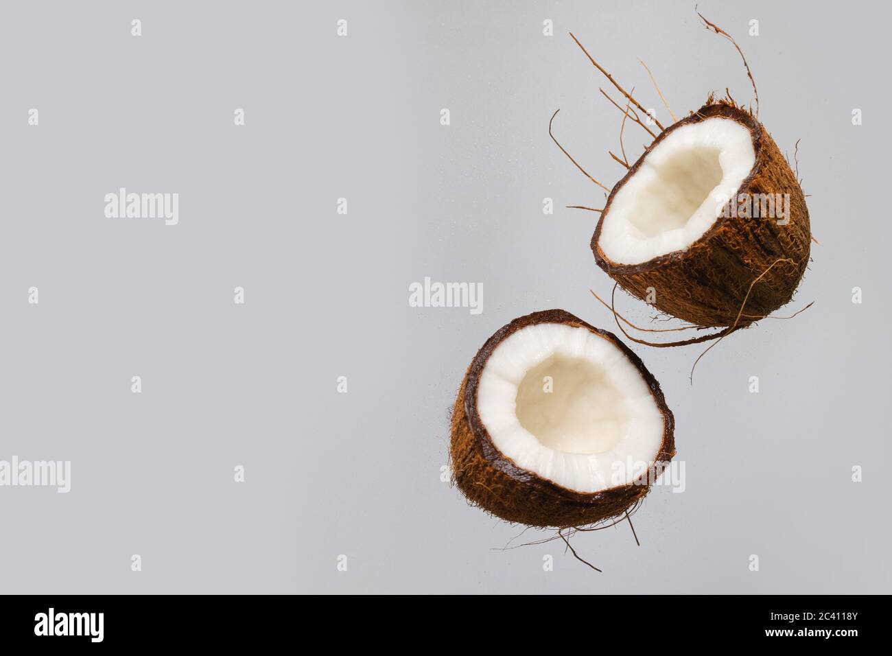 Fresh ripe coconut in the air isolated on pastel grey background Stock ...