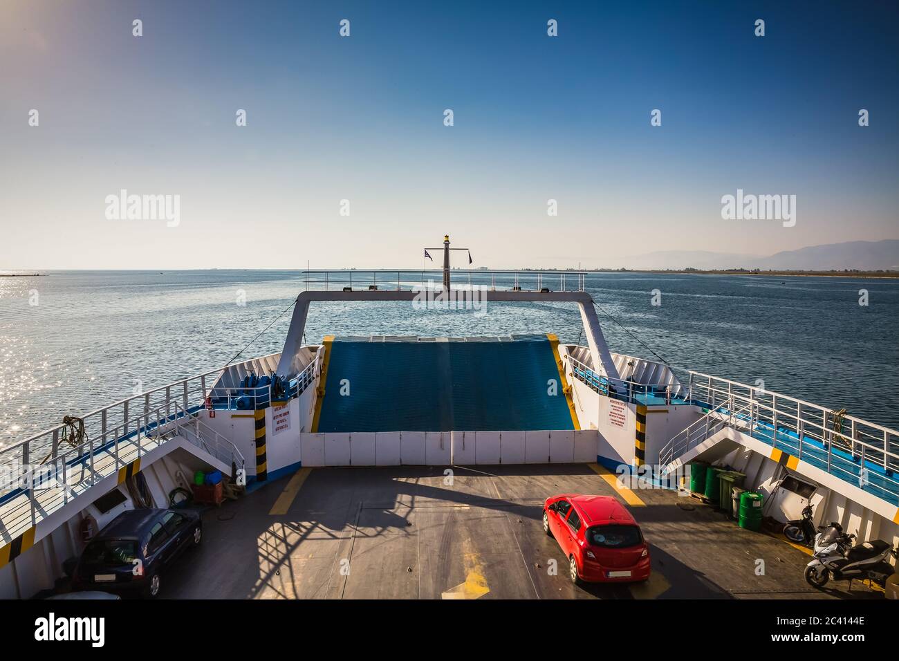 Cars on a ferry boat's deck on the open sea on a sunny summer day ...