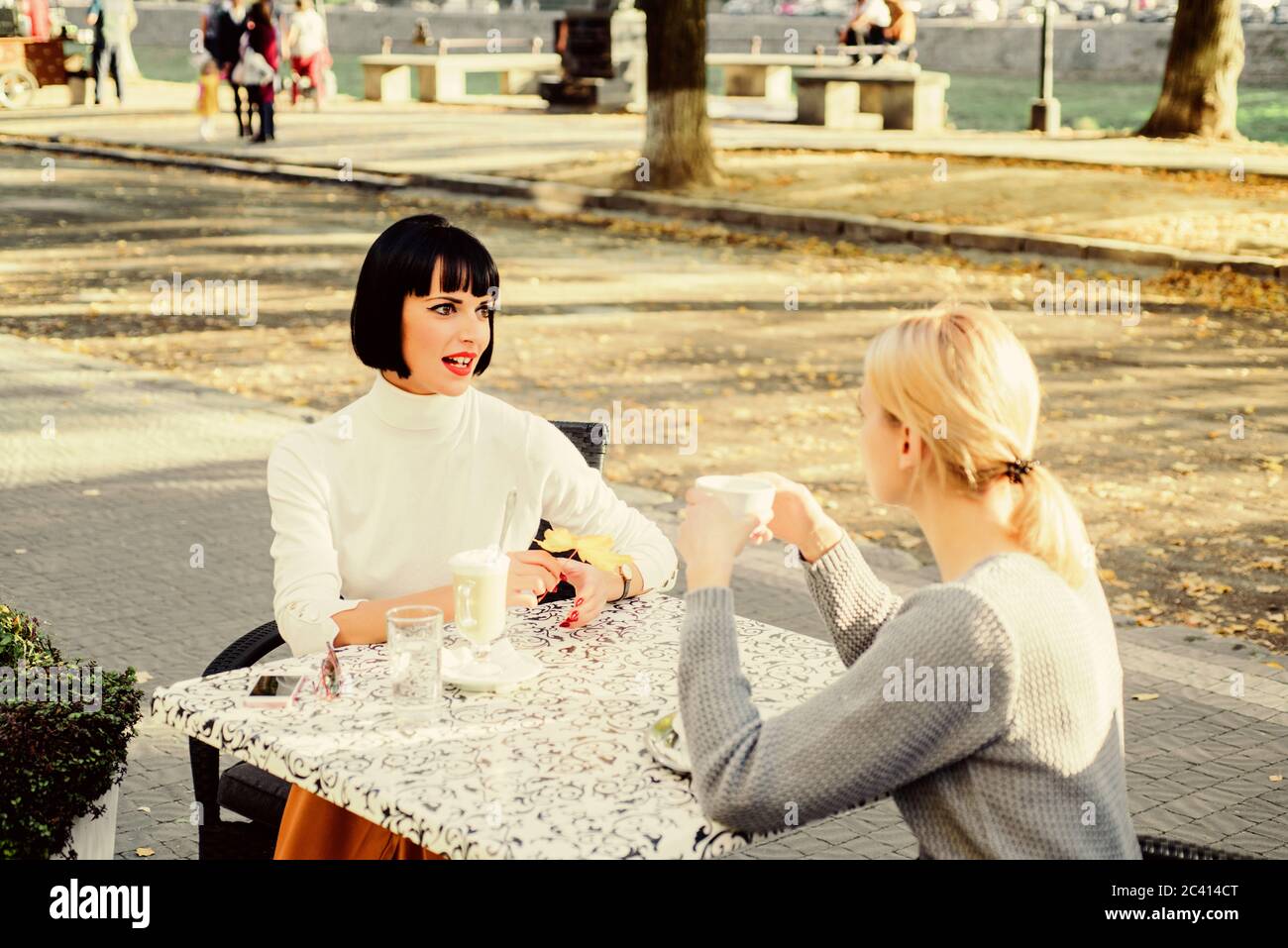 Conversation of two women cafe terrace. Friendship meeting. Sharing ...