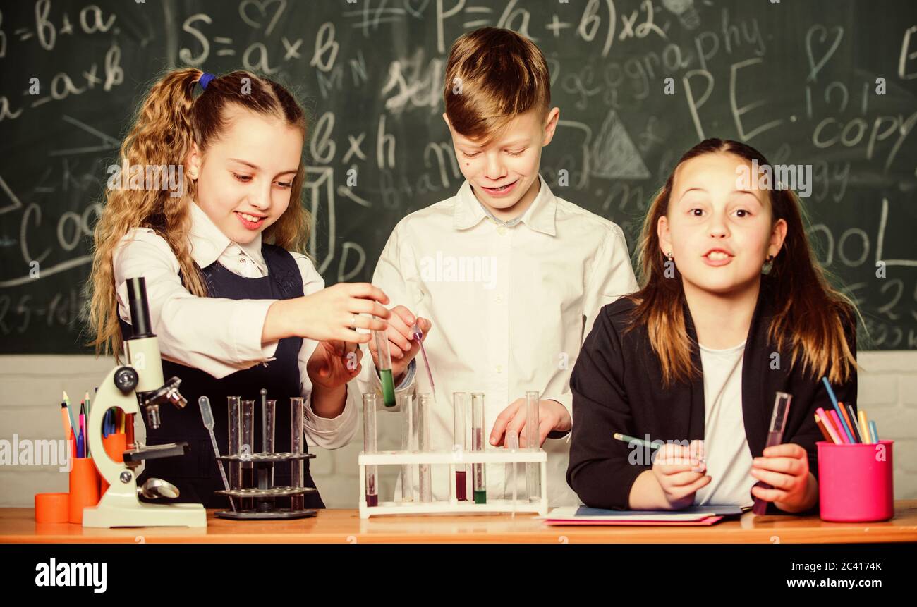 Group school pupils study chemical liquids. School chemistry lesson ...