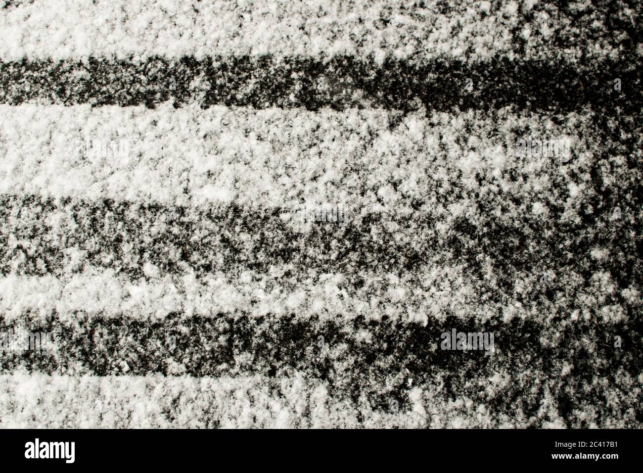 foot print on the road covered thin snow Stock Photo - Alamy