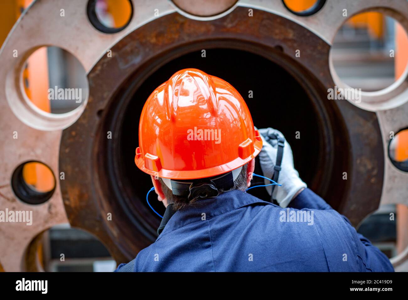 Offshore operator inspects pipe and flange before instal Stock Photo ...