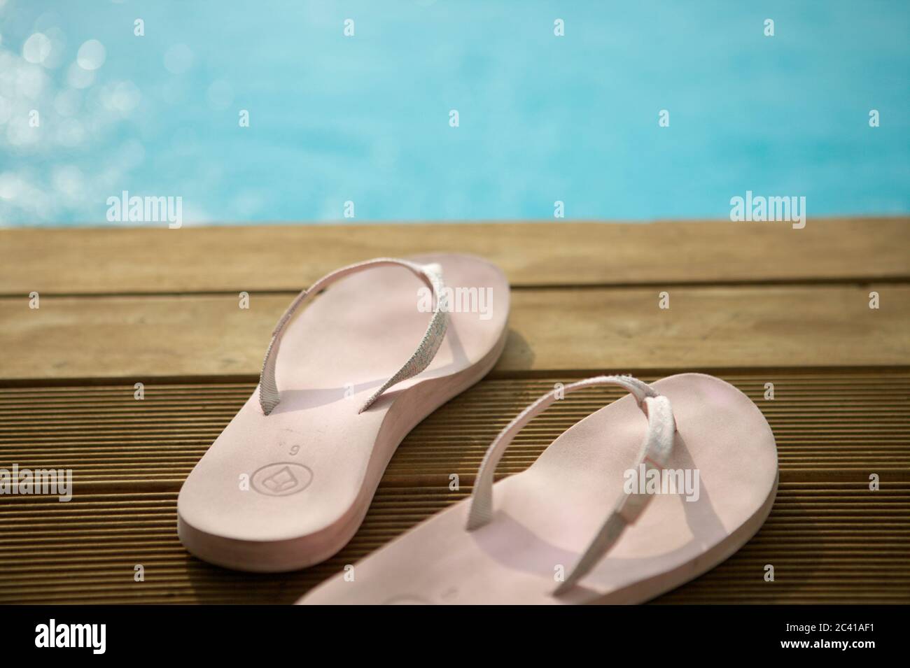 Flip flops by the pool - wellness Stock Photo - Alamy