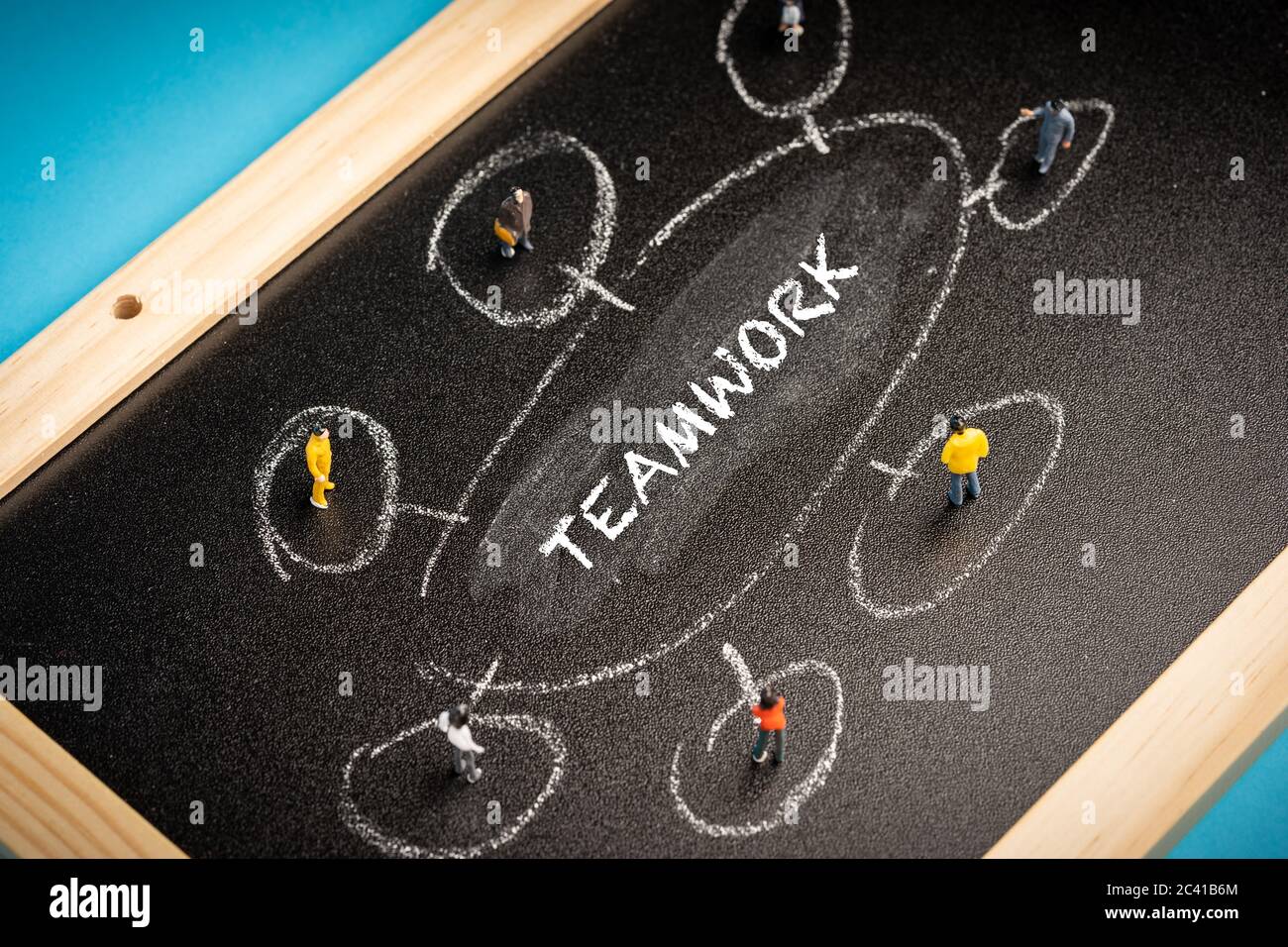 Business concept: Teamwork. A group of miniatures person on a ...