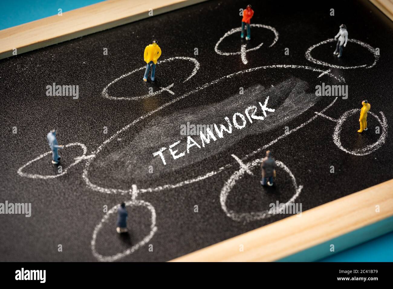 Business concept: Teamwork. A group of miniatures person on a ...