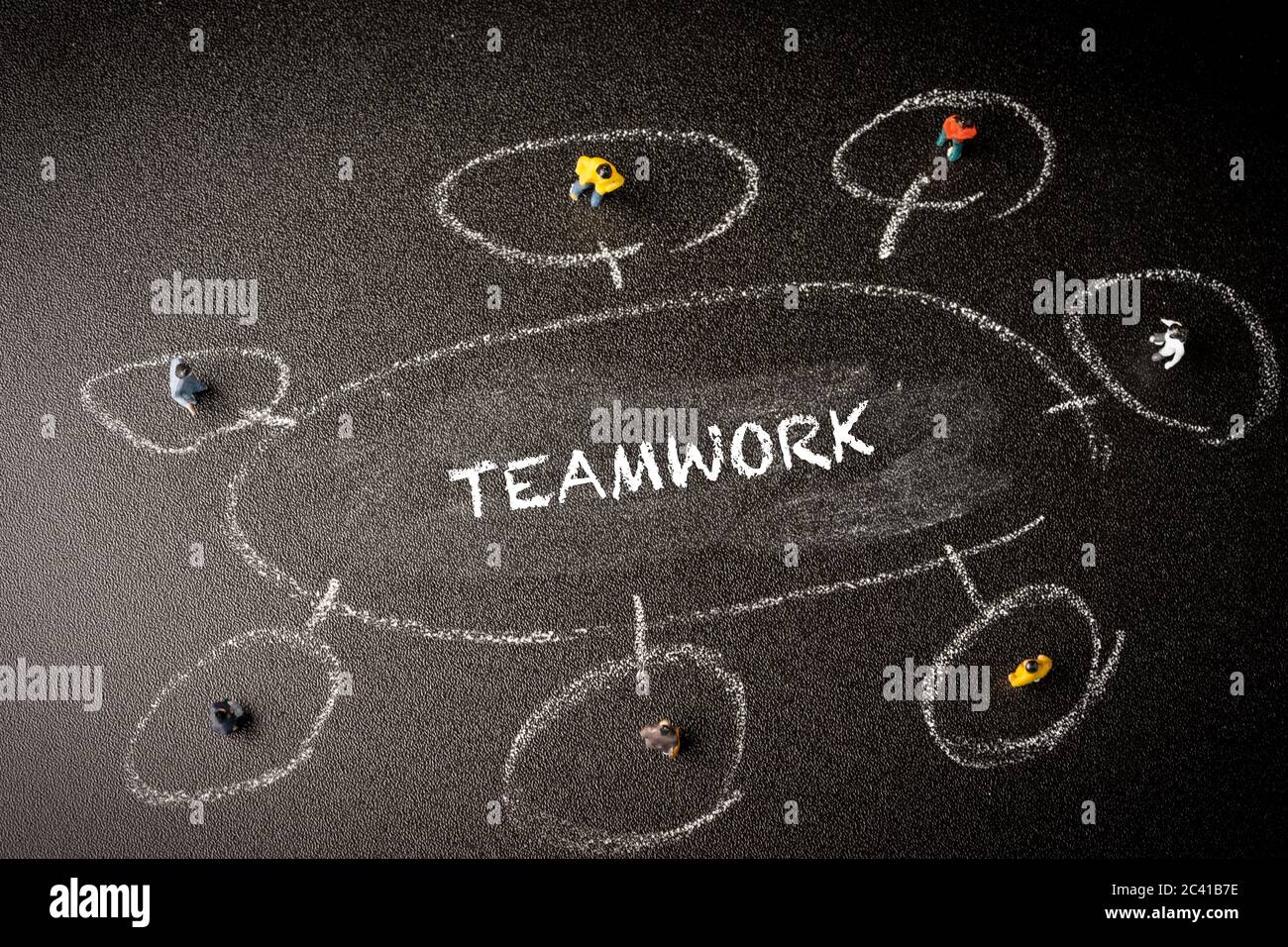 Business concept: Teamwork. A group of miniatures person on a ...