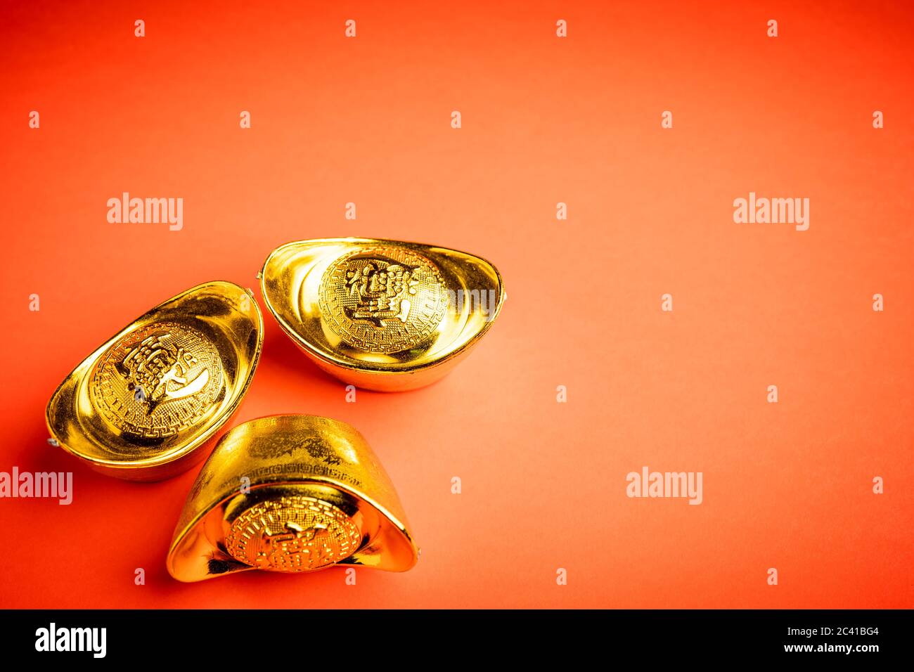 Chinese gold bars against red background. The wordings on bar is ...