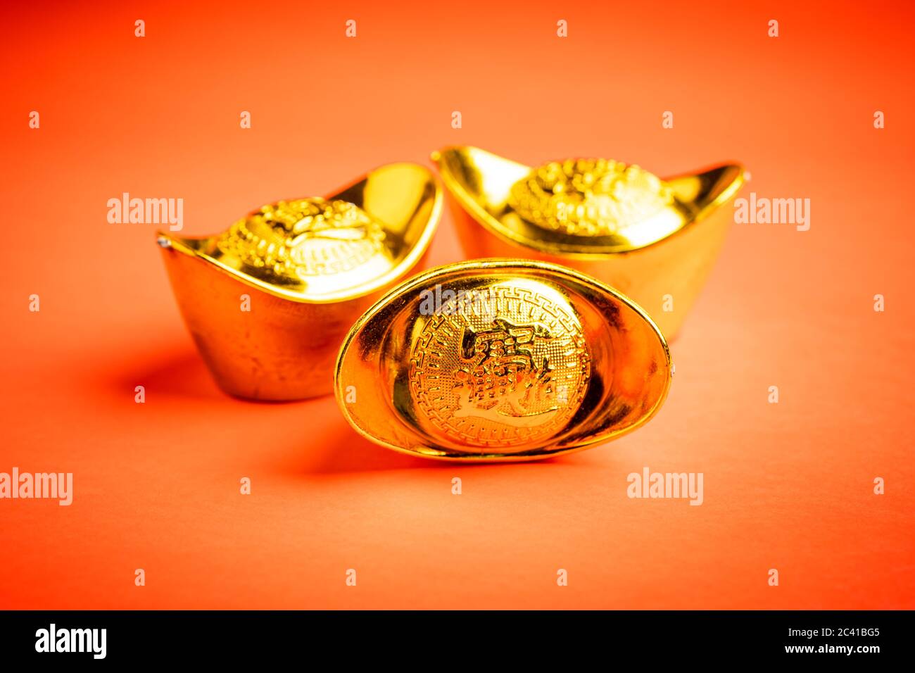 Chinese gold bars against red background. The wordings on bar is ...