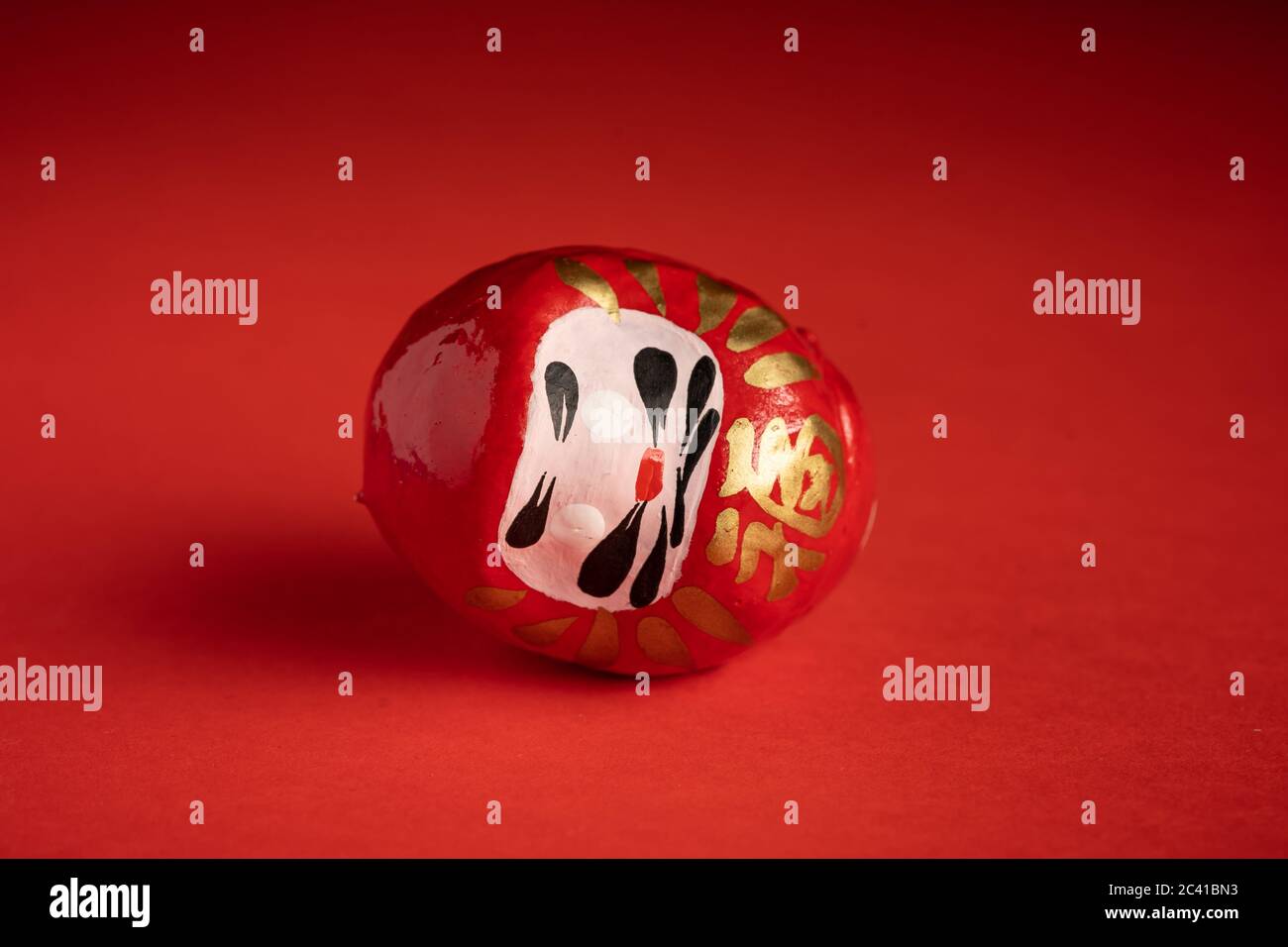 Daruma doll on red background, japanese doll Stock Photo - Alamy