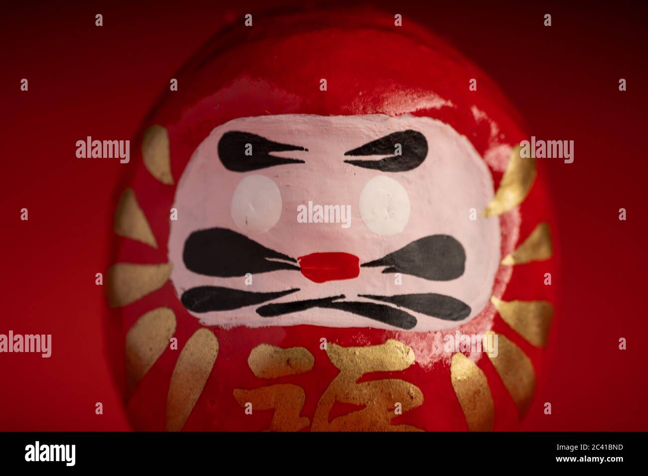 Daruma doll on red background, japanese doll Stock Photo - Alamy