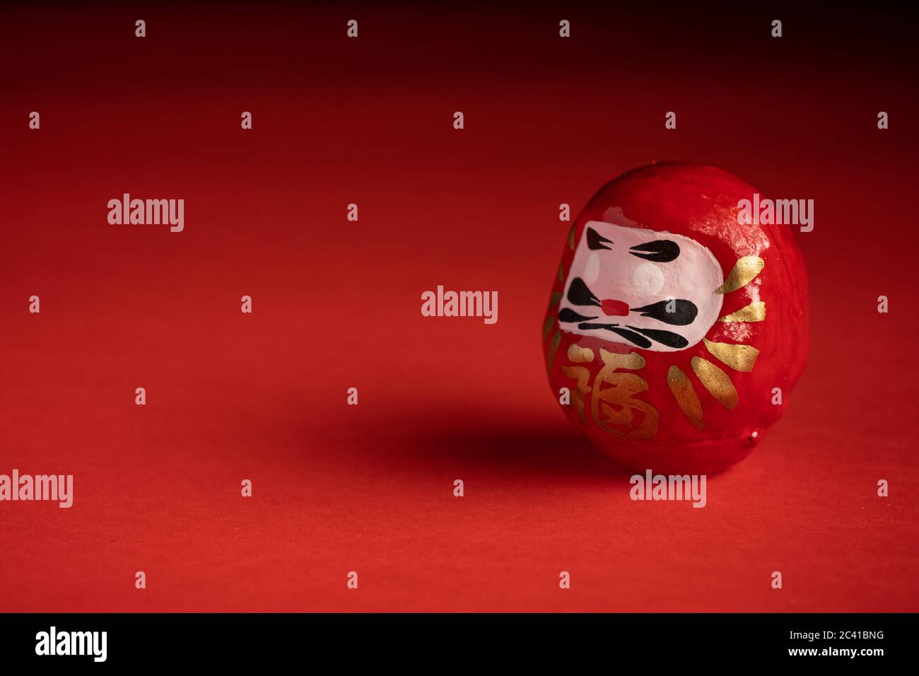 Daruma doll on red background, japanese doll Stock Photo - Alamy