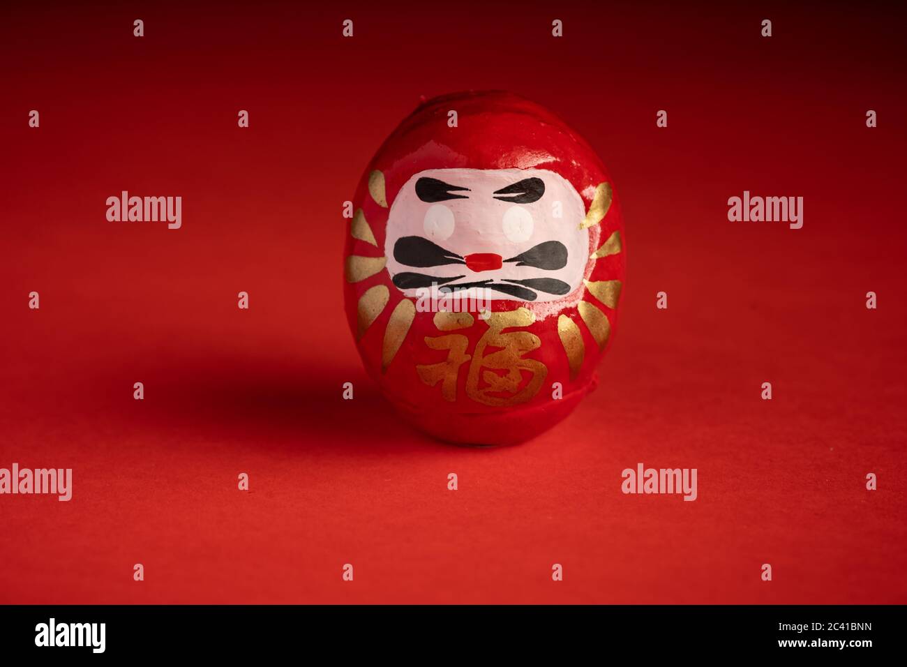 Daruma doll on red background, japanese doll Stock Photo - Alamy