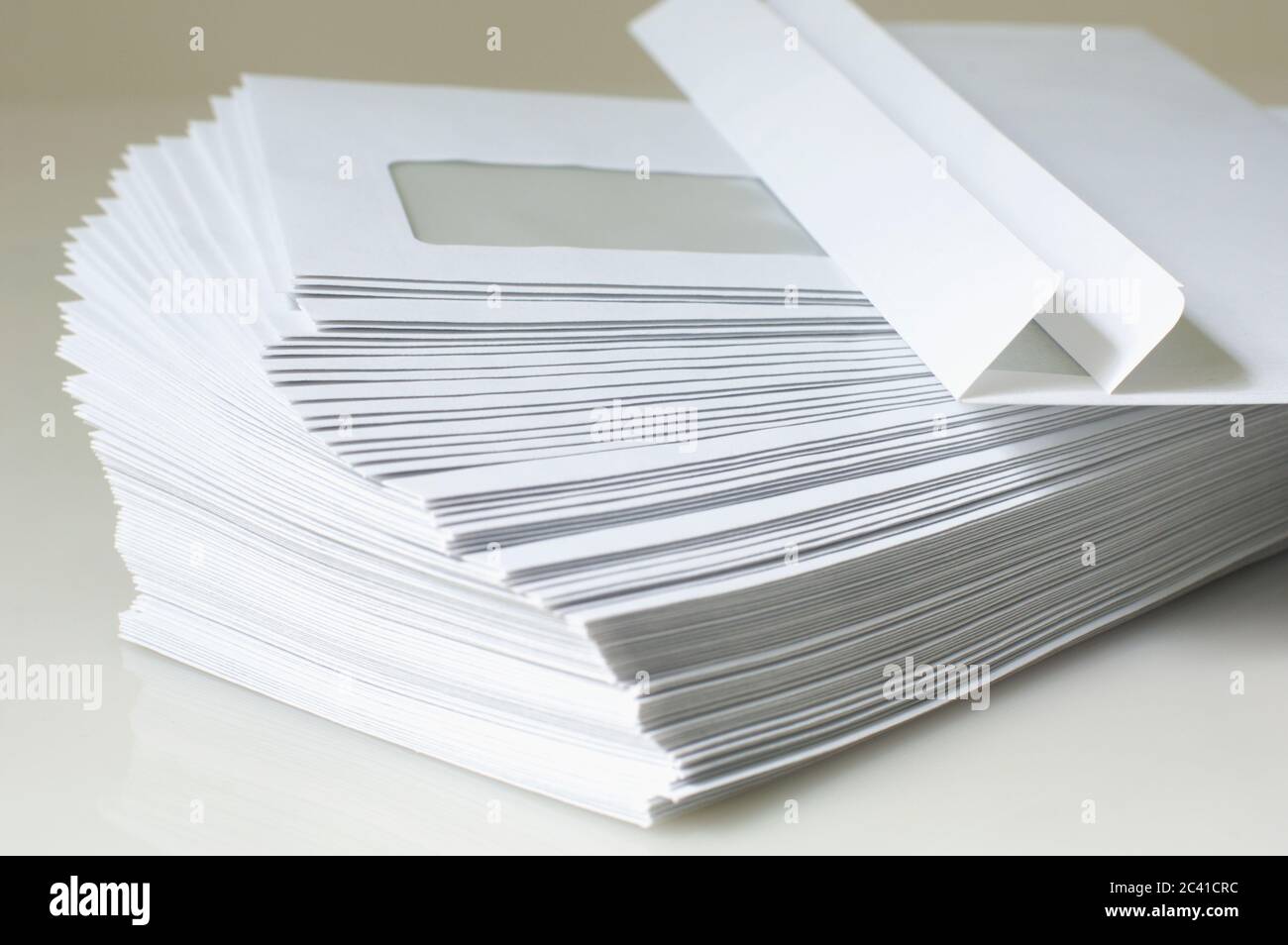 A stack of white envelopes with an address window Stock Photo - Alamy