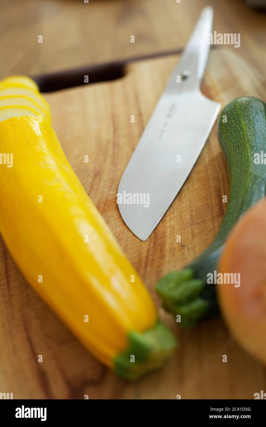Zucchini and knife on a kitchen board Stock Photo - Alamy