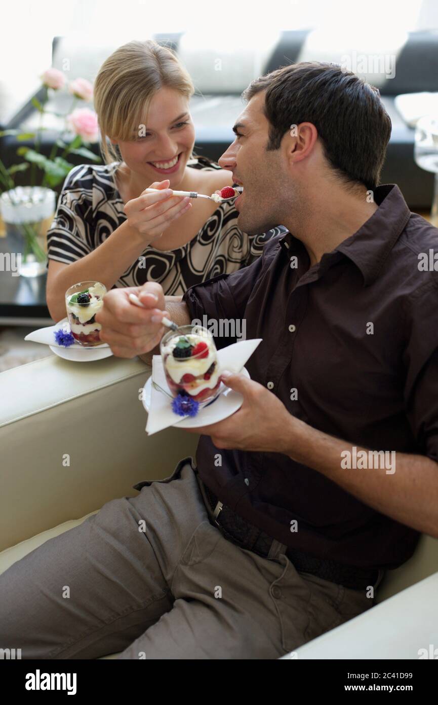 Woman feeds man with a dessert Stock Photo - Alamy
