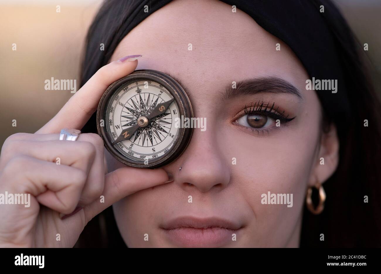 girl eyes with a compass Stock Photo - Alamy