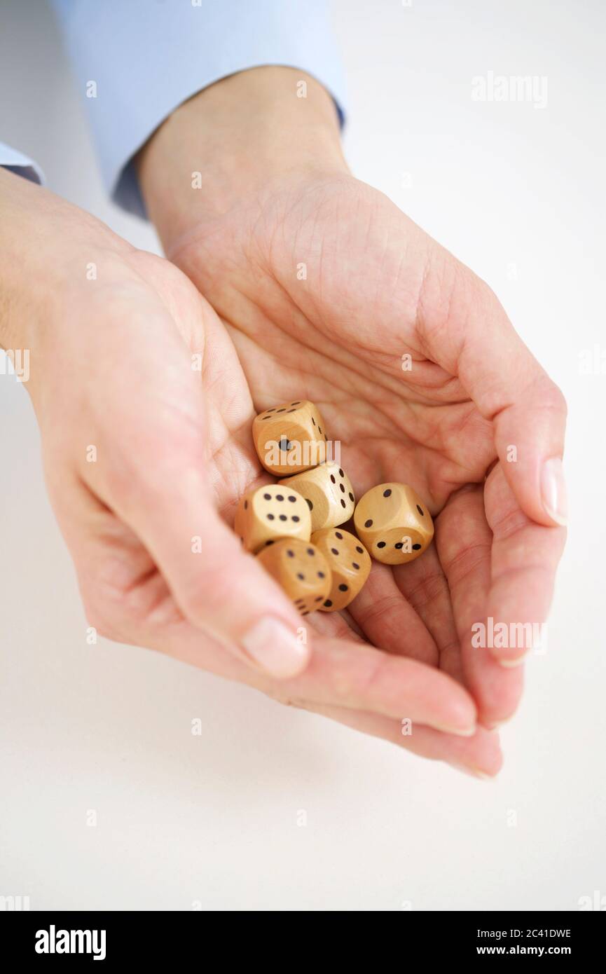 Dice in cupped hands Stock Photo - Alamy