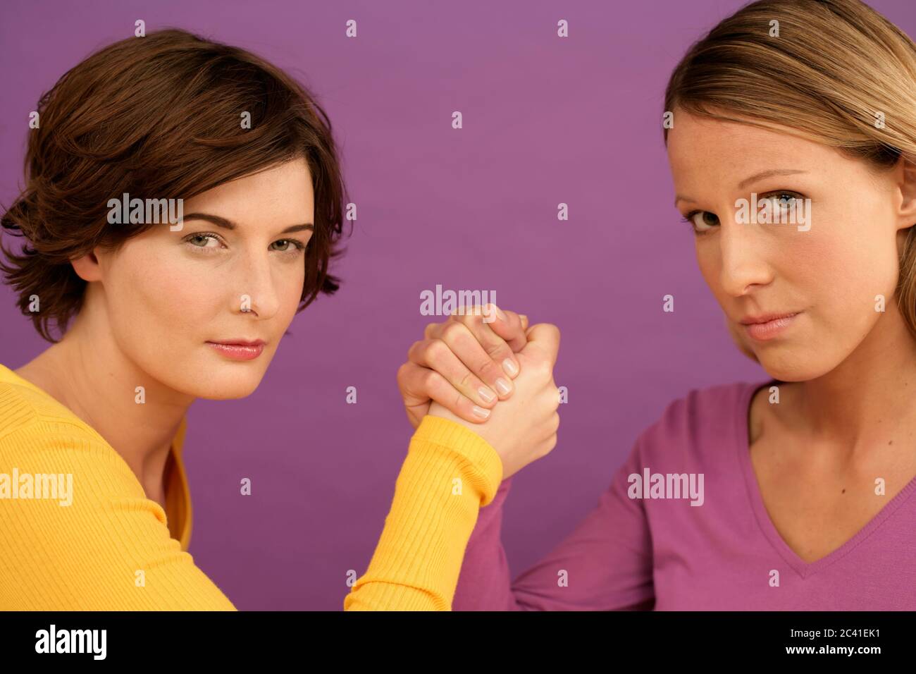 Two women do arm wrestling Stock Photo - Alamy