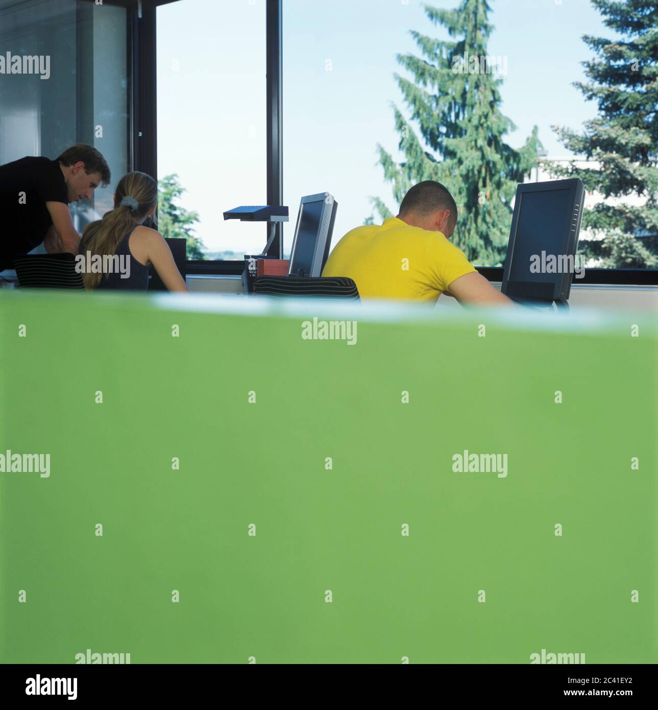 Three people work in an office - teamwork Stock Photo - Alamy