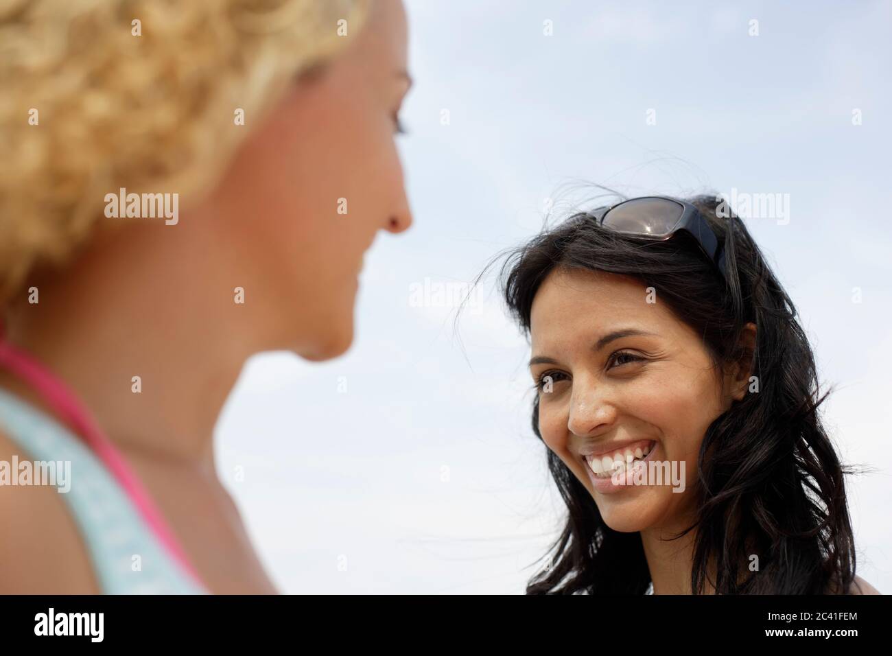 Two young women face each other - girlfriends - free time Stock Photo ...