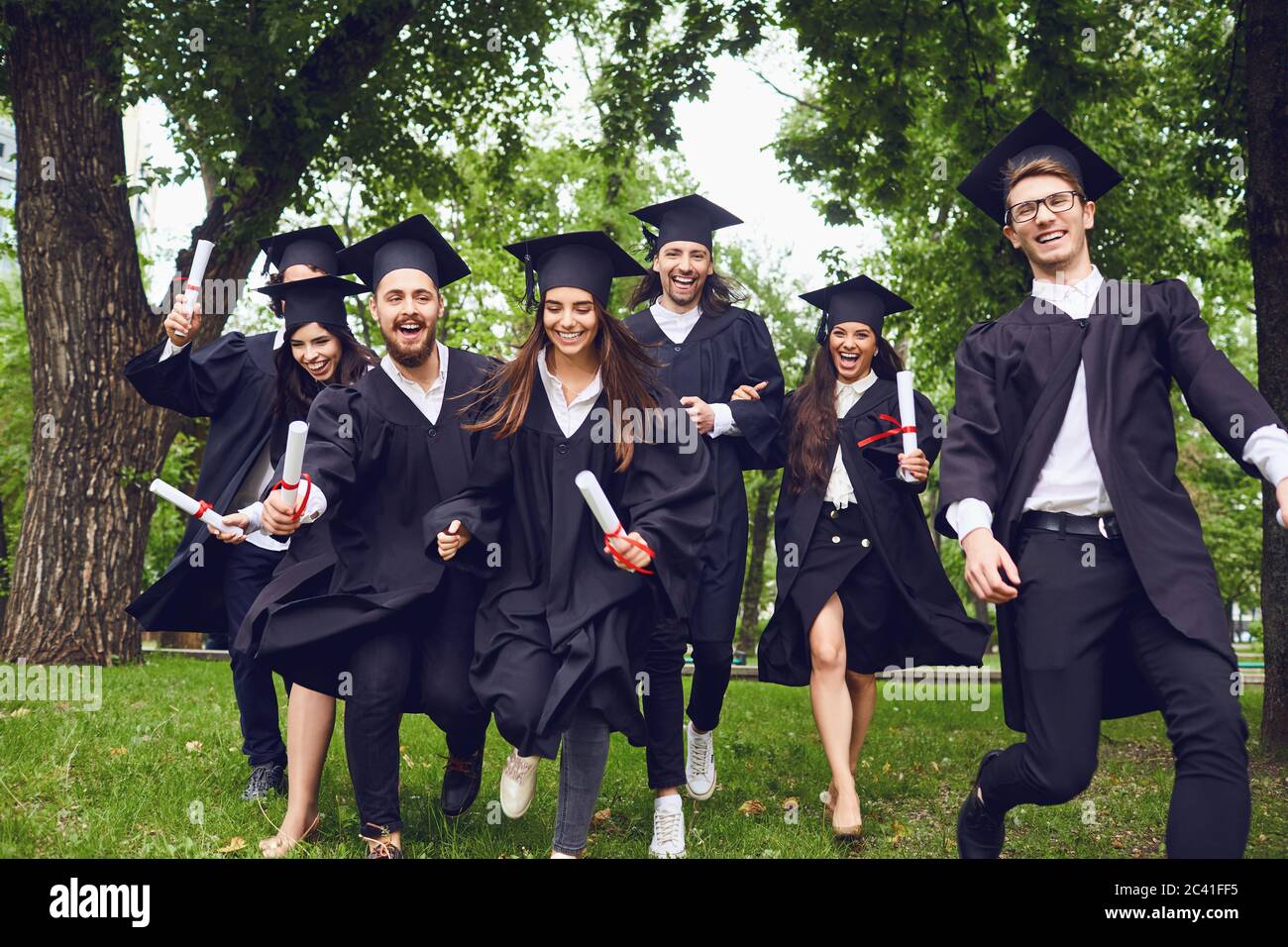 A group of graduates smiling Stock Photo - Alamy