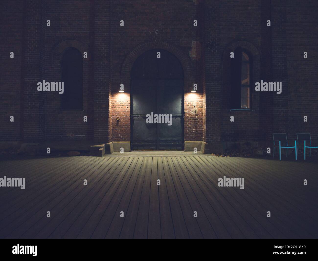 Dim lights in front of big metal doors at night. Location: Turku ...