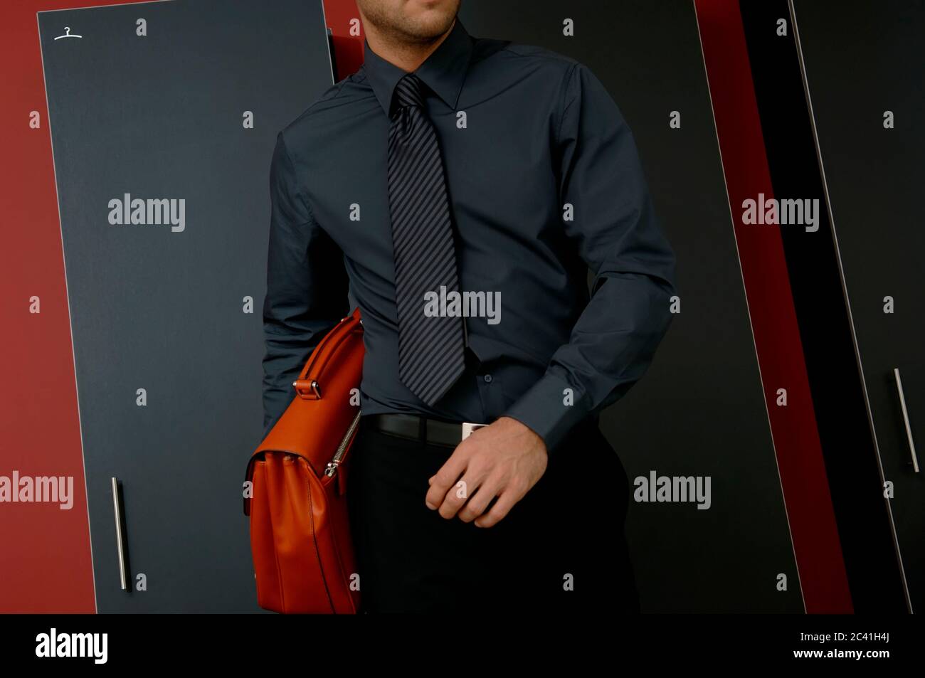 Tie under his arm hi-res stock photography and images - Alamy