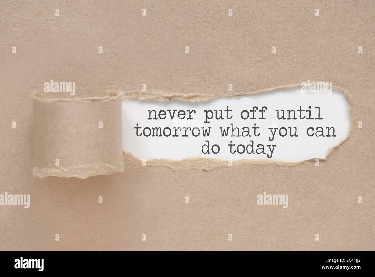 Torn paper revealing the expression never put off until tomorrow what ...