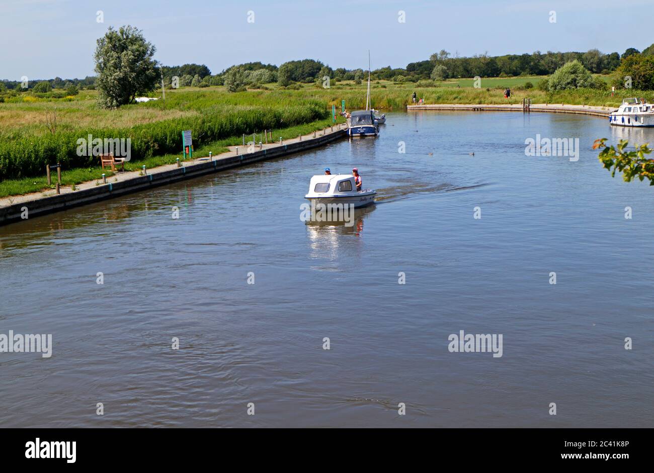 A couple in a small pleasure craft making way towards Ludham Bridge on ...