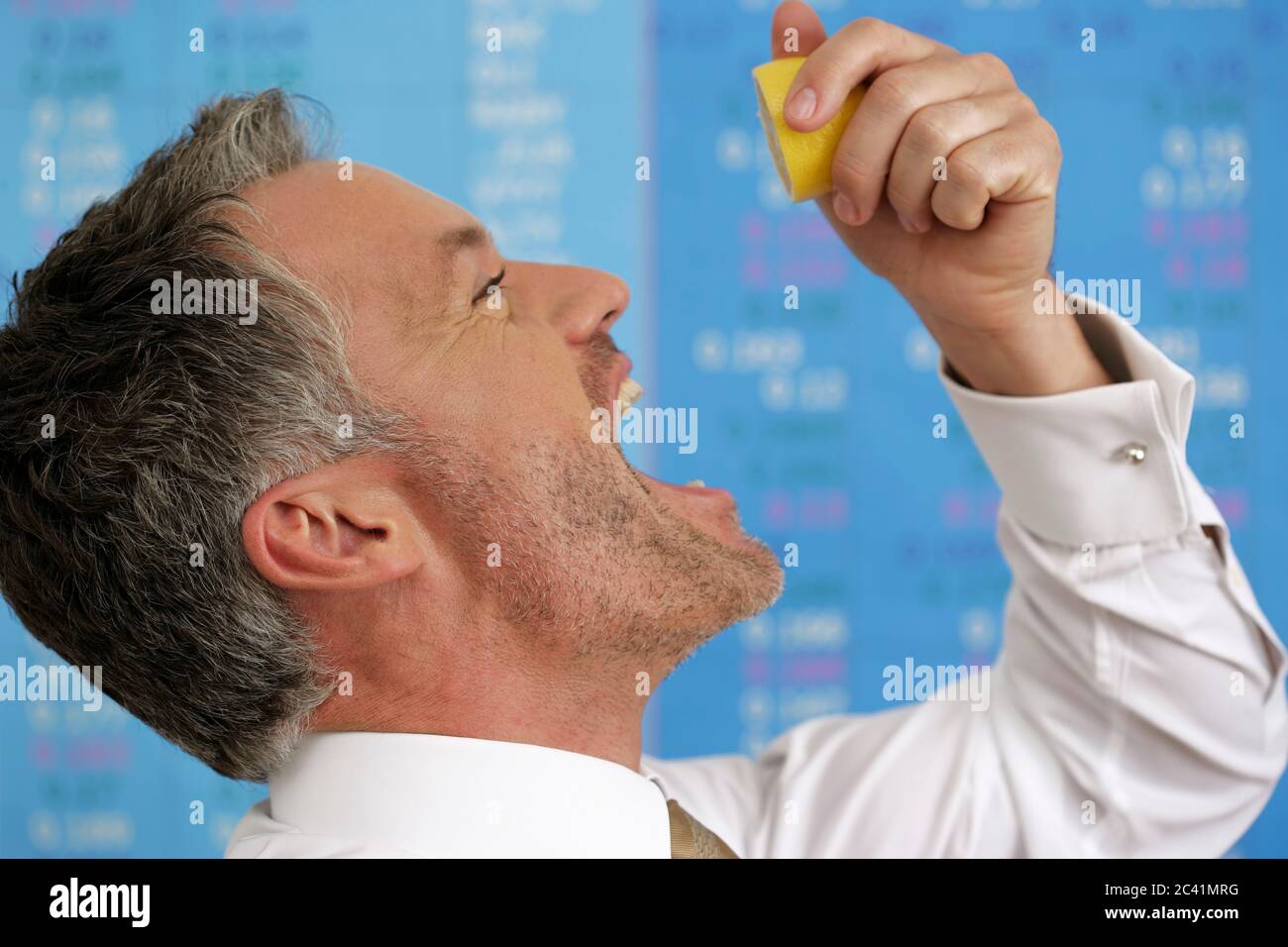 Stockbroker in front of scoreboard drops lemon juice in his mouth Stock ...