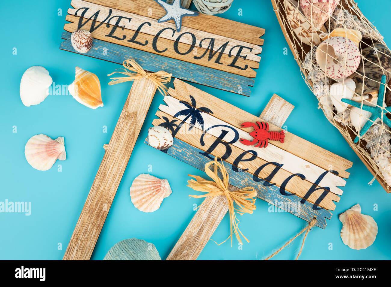 Wooden signs welcome beach and shells on blue background Stock Photo ...