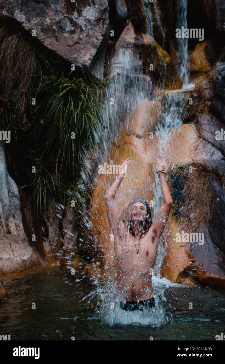 Boy in a natural pool pulling water Stock Photo - Alamy