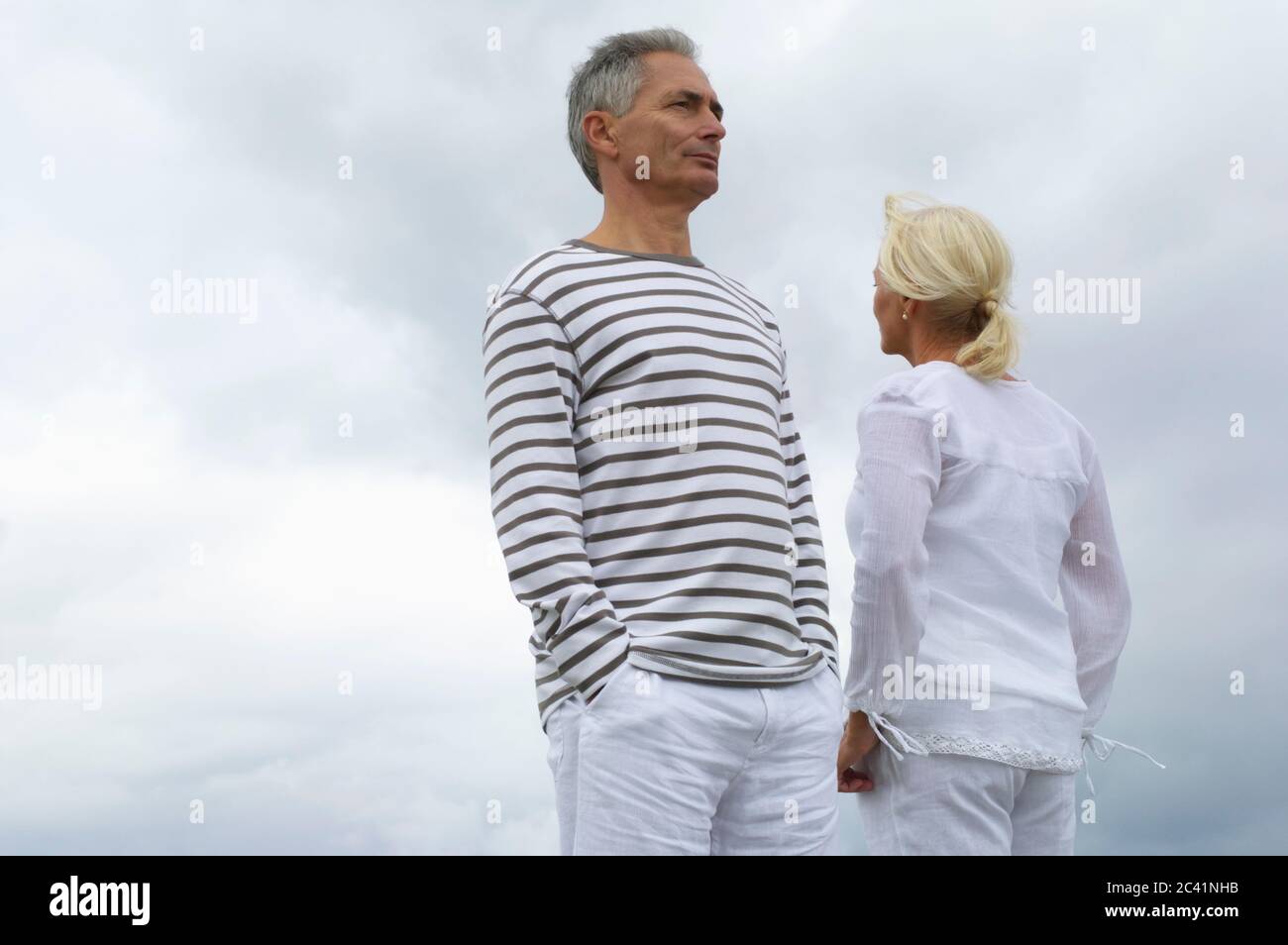 Couple look in opposite directions Stock Photo - Alamy