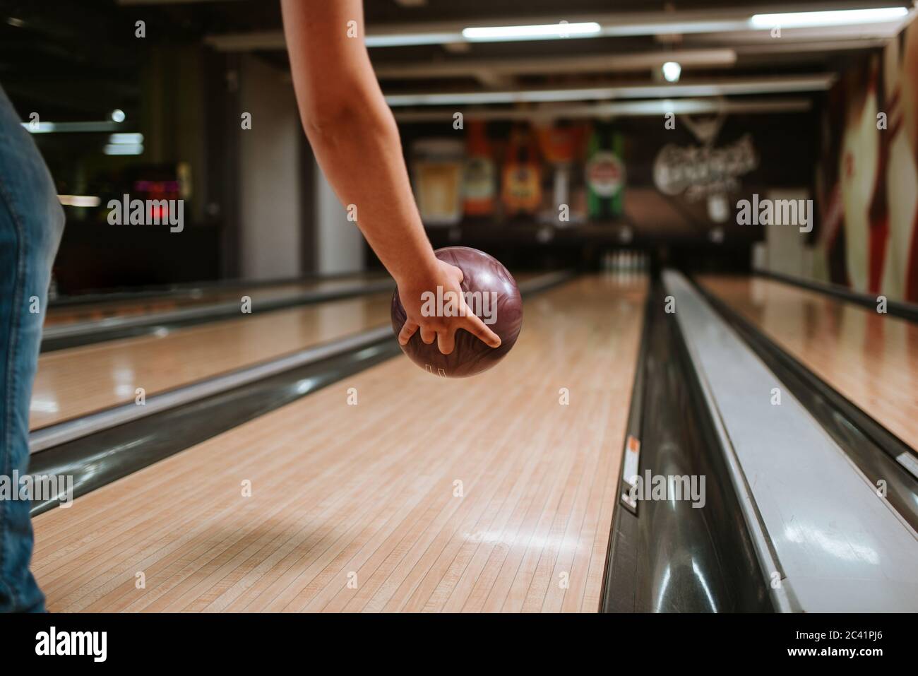 Close up of the hand of a caucasian man throwing a ball in a bowling ...