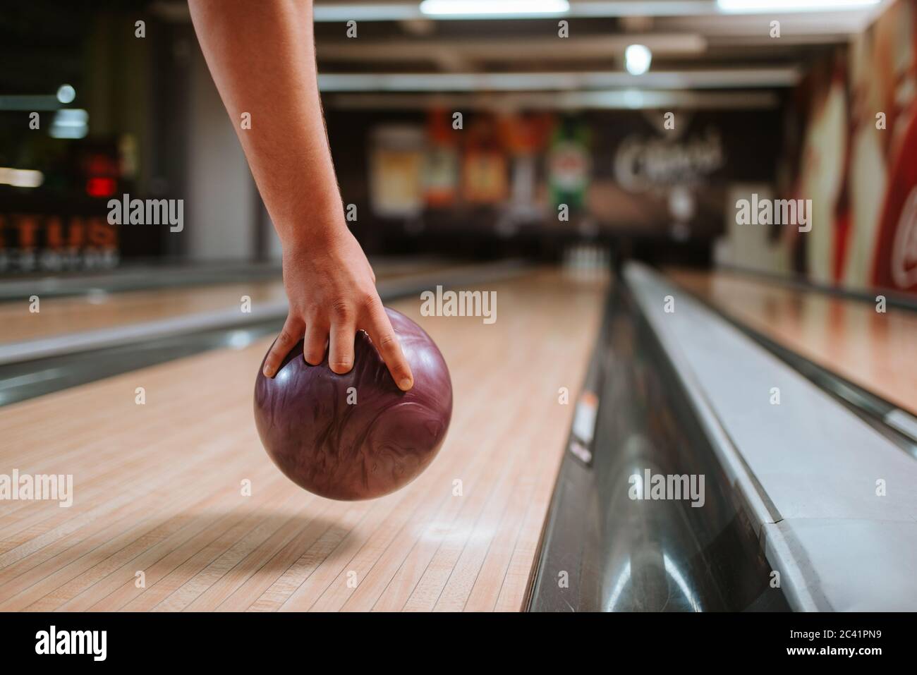 Close up of the hand of a caucasian man throwing a ball in a bowling ...
