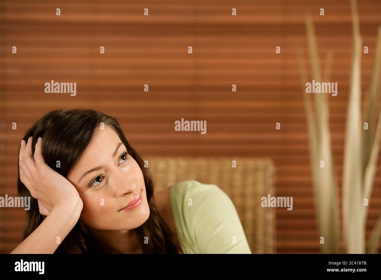 Pensive woman supports head on her hand Stock Photo - Alamy