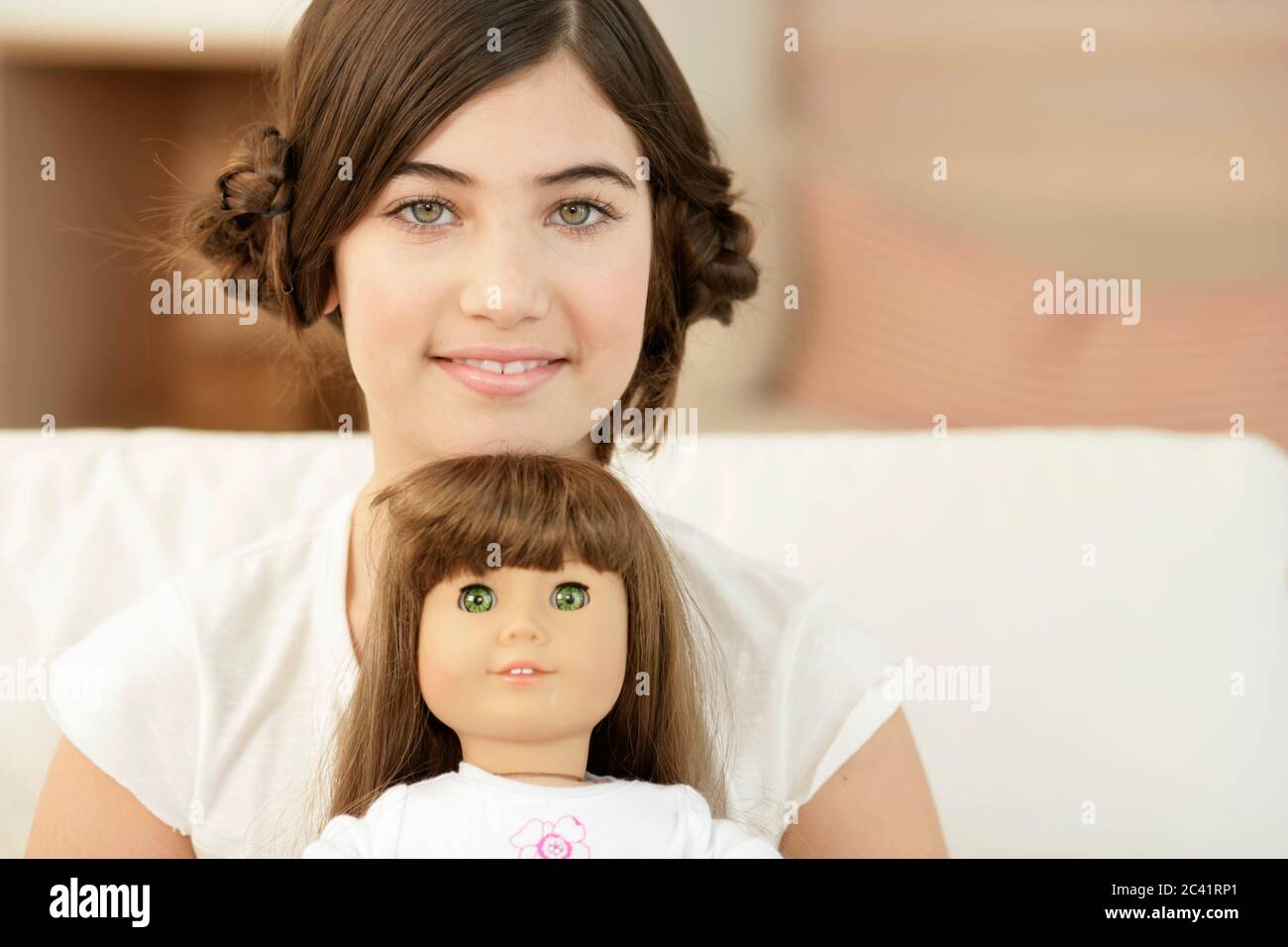 Girl holds doll in her arms Stock Photo - Alamy