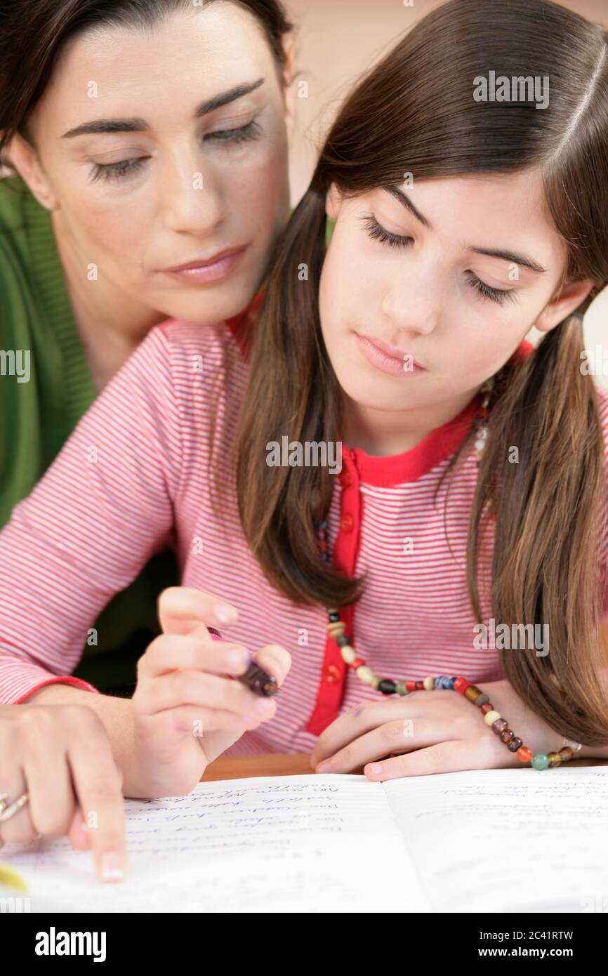 Mother and daughter do homework together Stock Photo - Alamy