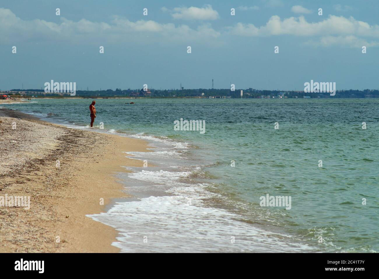 Lonely man on the beach of the Sea of Azov, Primorsk, Ukraine Stock ...