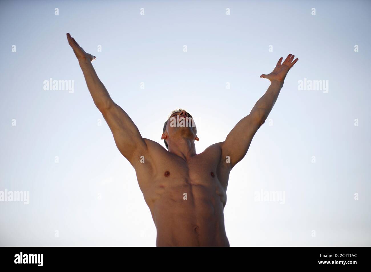 Man stretches his arms up Stock Photo - Alamy