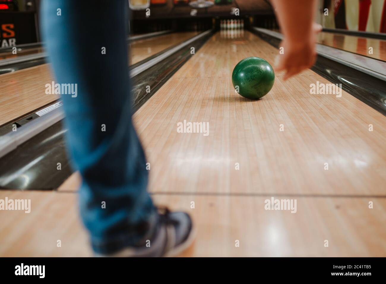Close up of the hand of a caucasian man throwing a ball in a bowling ...